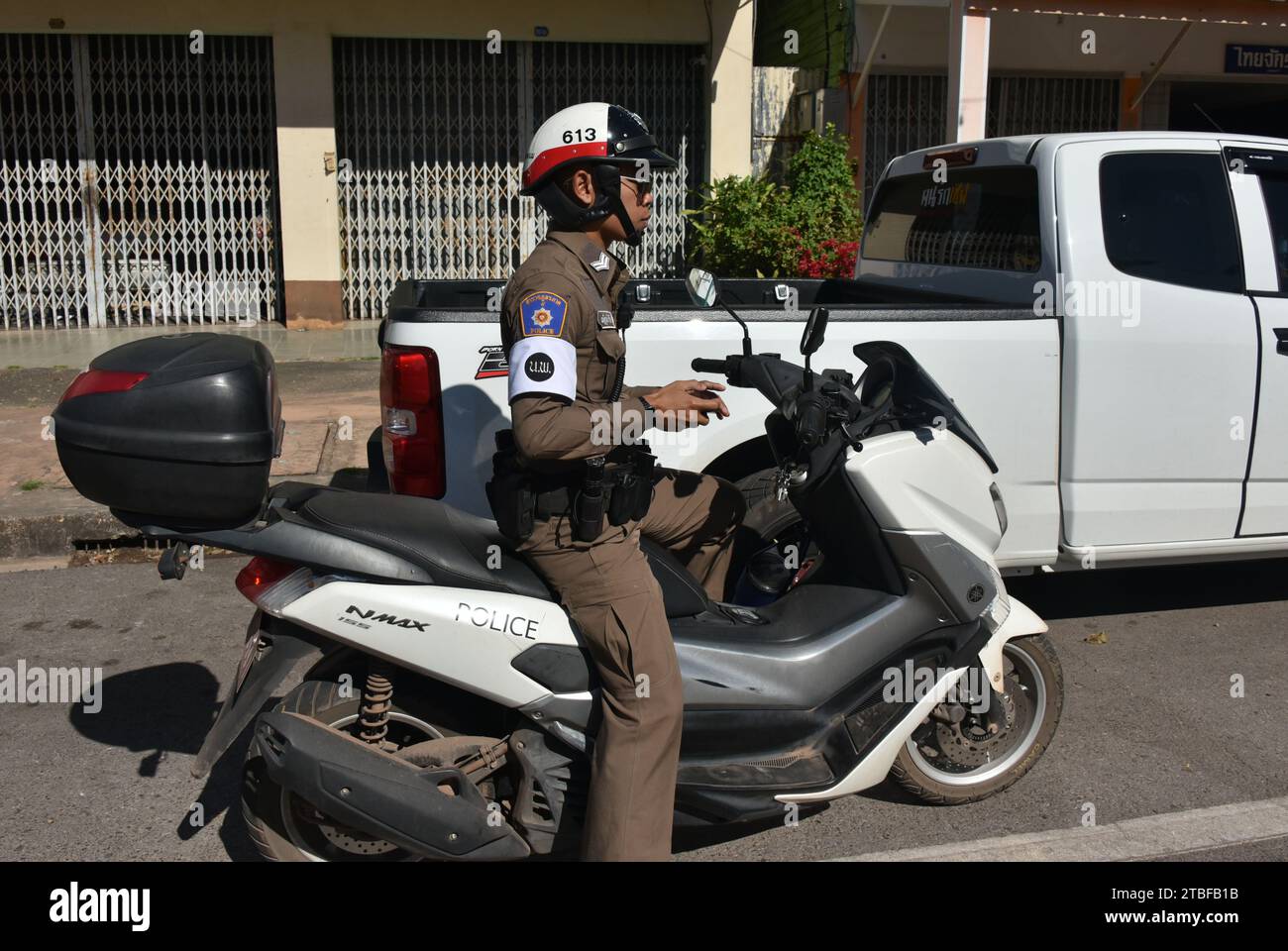 A male police officer on a motorbike in Nakhon Phanom, Isaan region ...