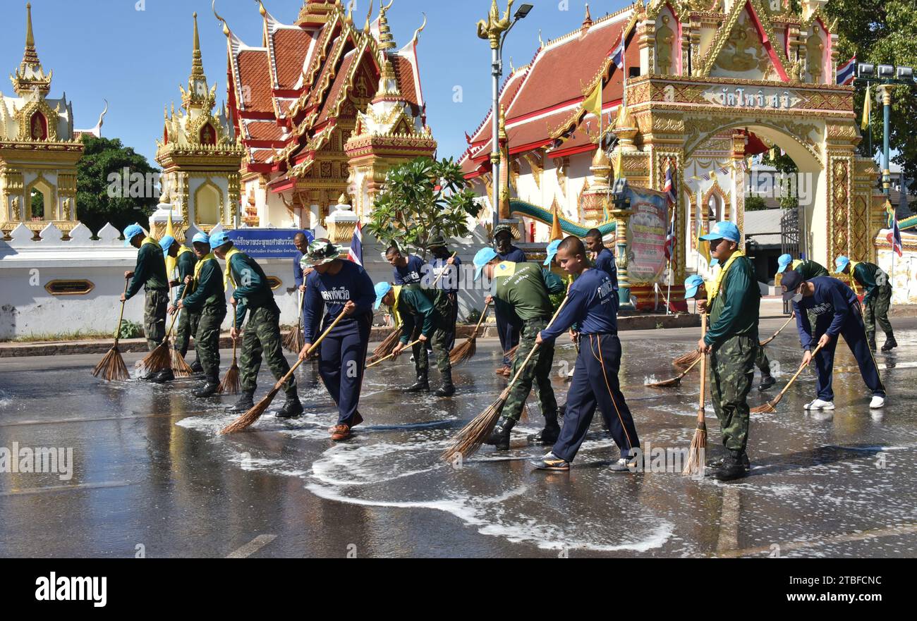 Young representatives of the Royal Thai Army help others in a national ...