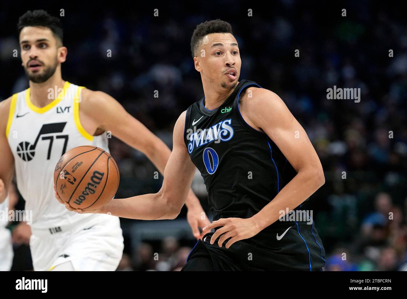 Dallas Mavericks guard Dante Exum (0) brings the ball up court in front ...