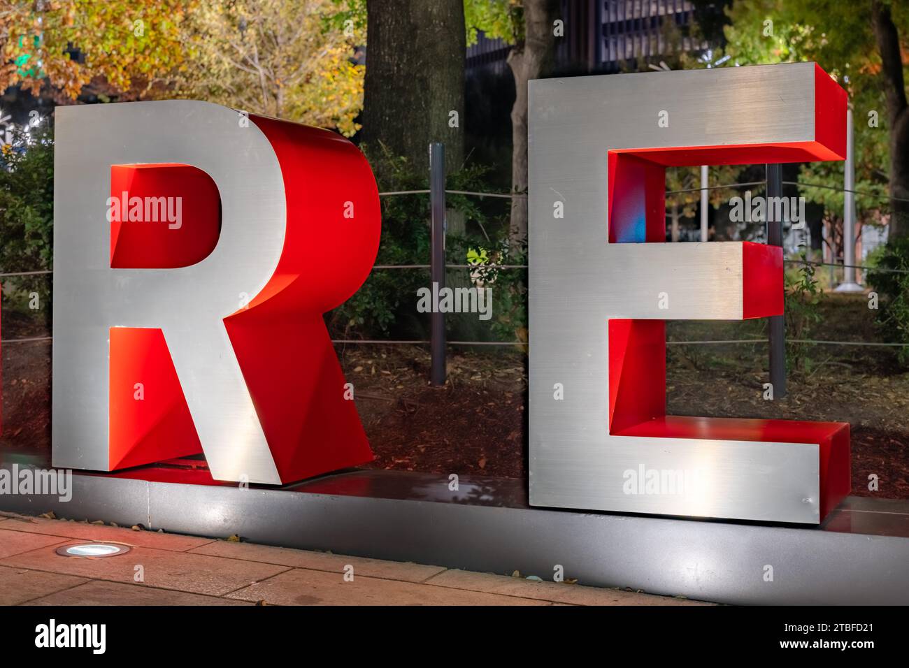 Red and gray three-dimensional 3d letters RE with an evening outdoor ...