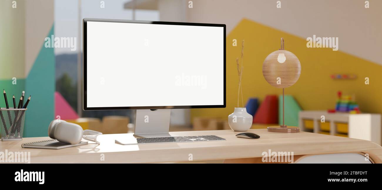 A computer desk in a colorful kid nursery or classroom with a white ...