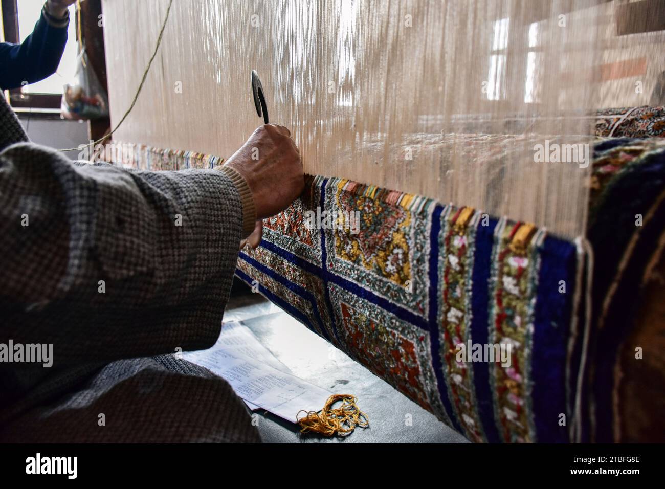 A Kashmiri artisan weaves a traditional carpet at a factory in Srinagar ...