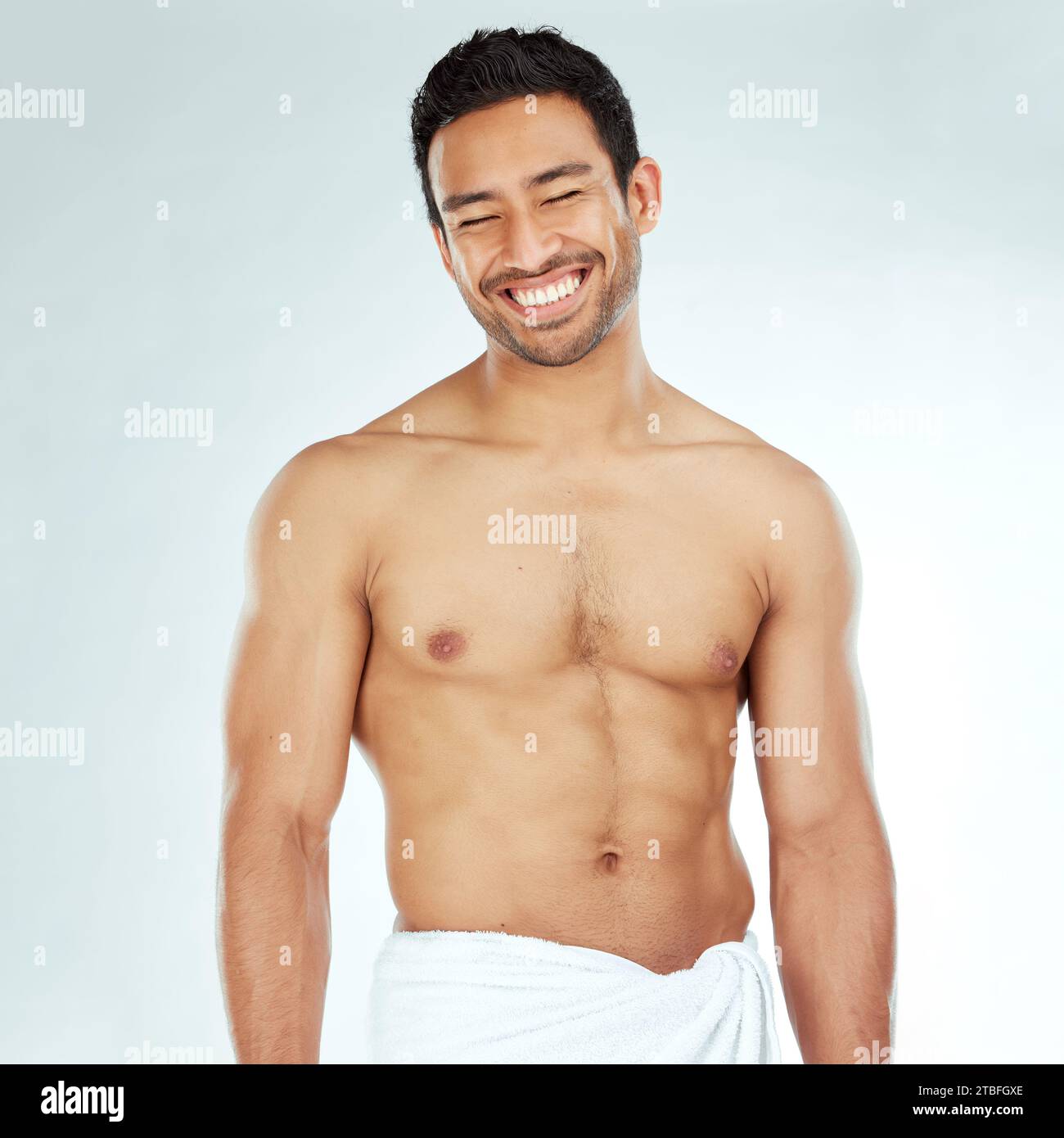 Body, cleaning and happy asian man in a towel in studio for beauty ...