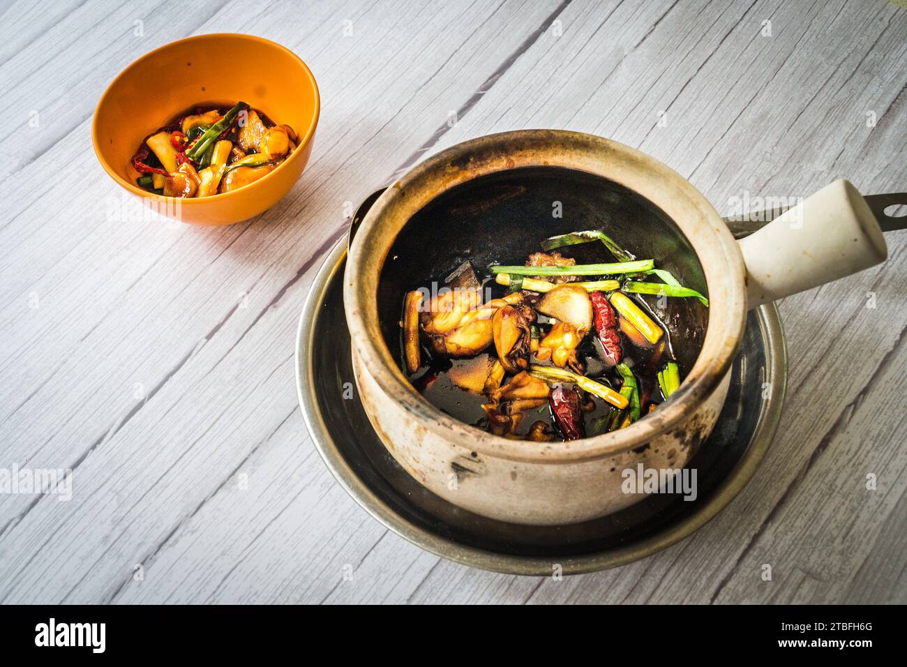 Stir fry frog leg with spring onions and dried reed chilli and served ...