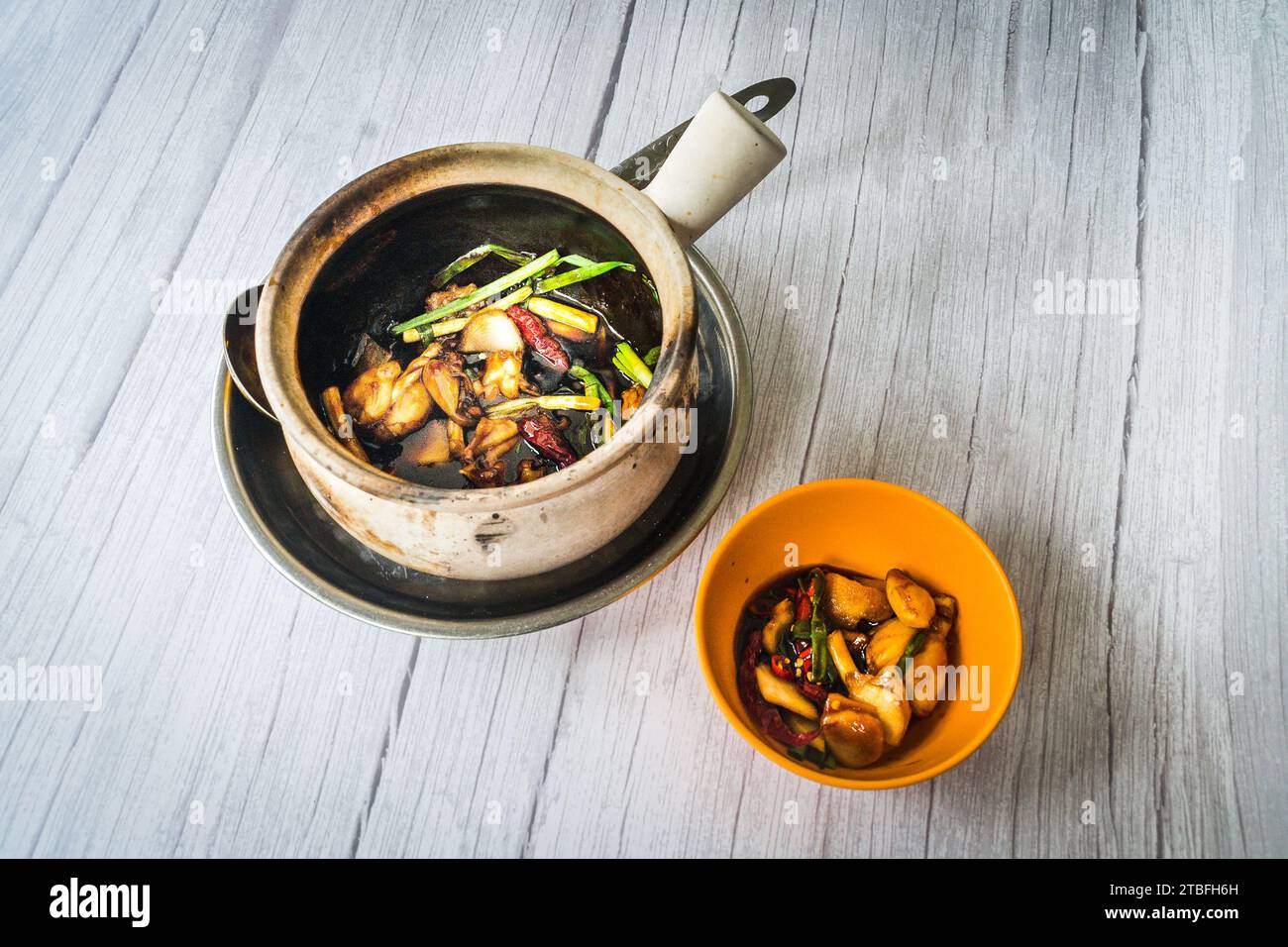 Stir fry frog leg with spring onions and dried reed chilli and served ...