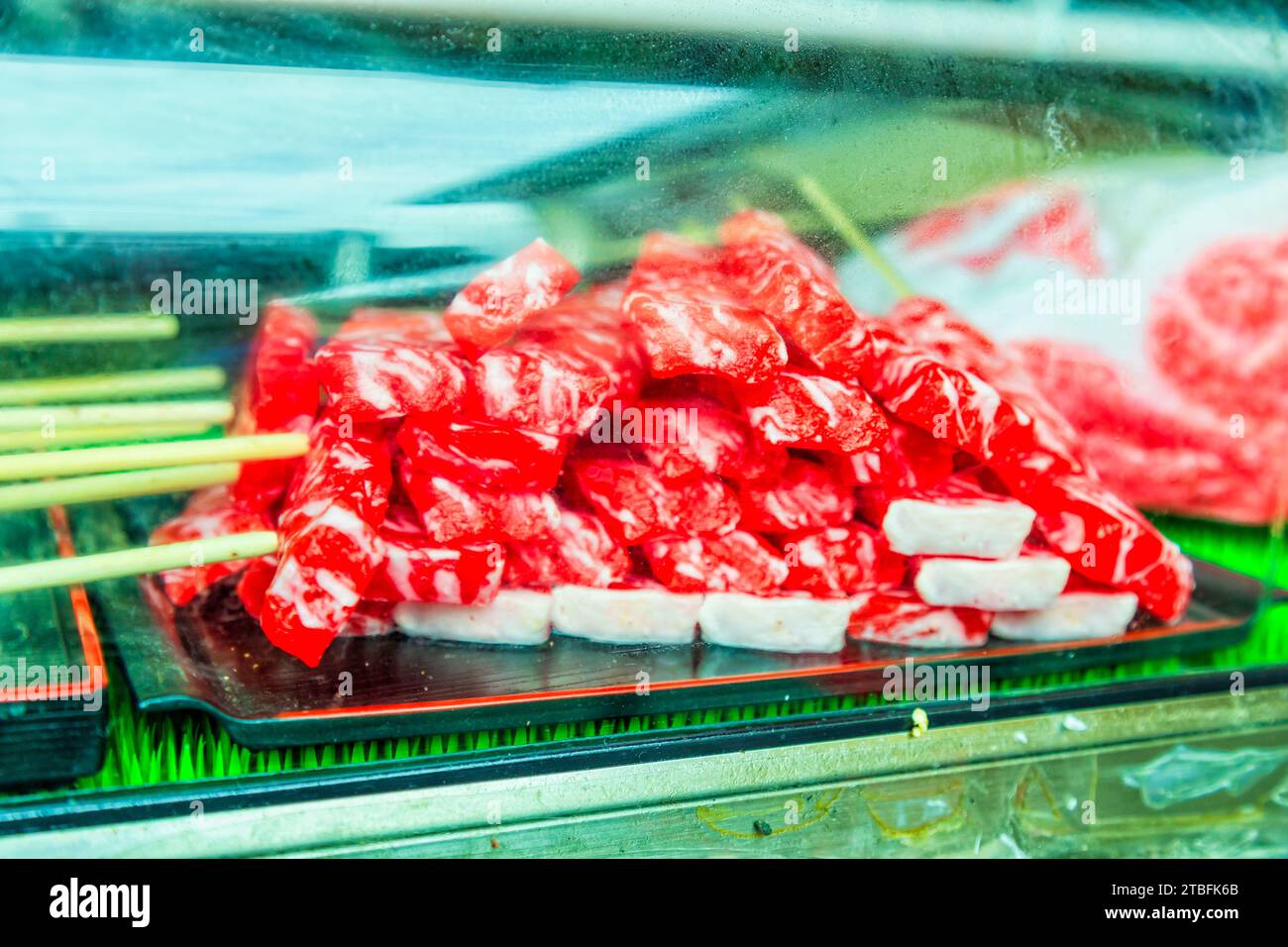 Meat skewers at a hot food stall on a shopping street in Japan city ...