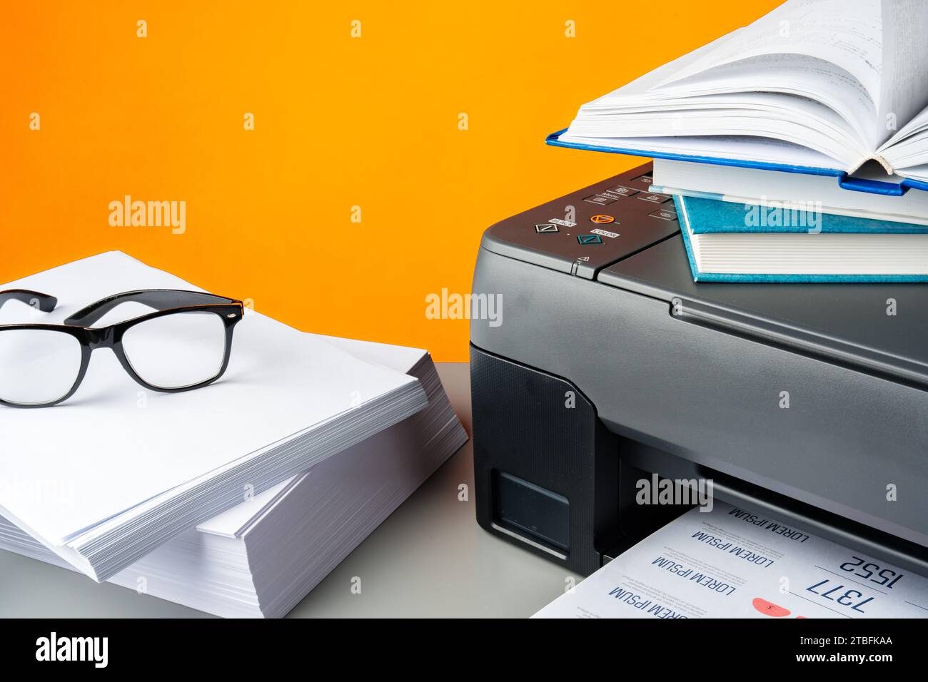 Laser printer on desk against yellow background Stock Photo - Alamy
