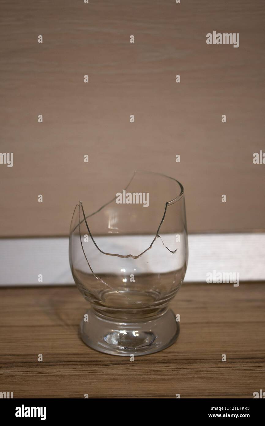 Broken transparent drinking glass in the kitchen. Sharp dangerous ...