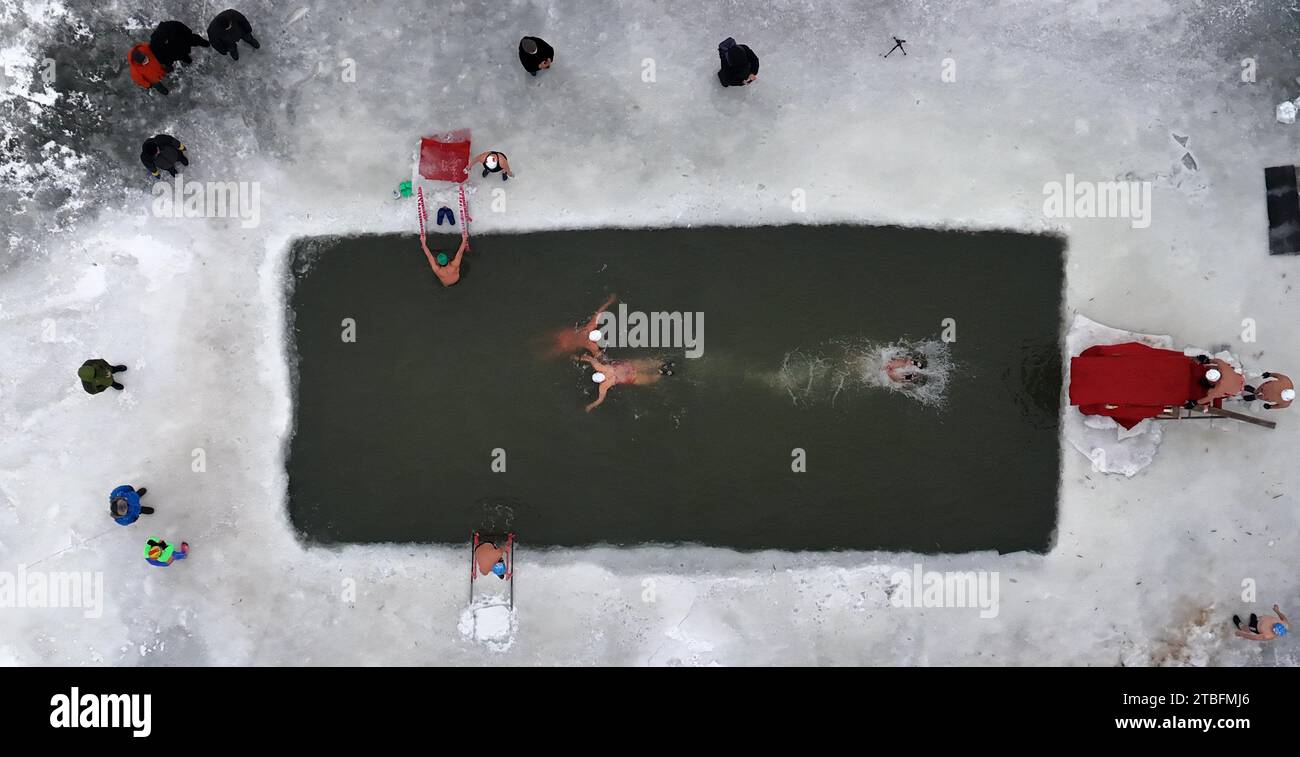 Winter swimming enthusiasts dive into the icy Songhua River in Harbin ...