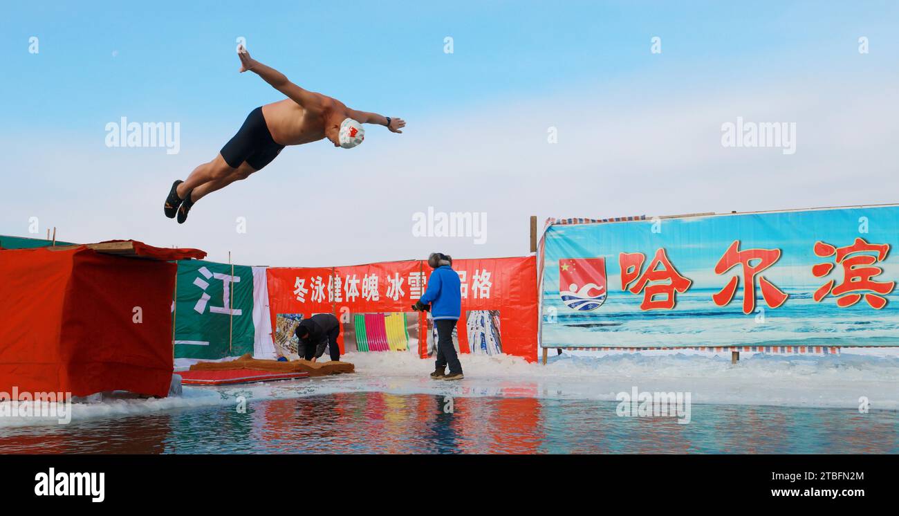 Winter swimming enthusiasts dive into the icy Songhua River in Harbin ...