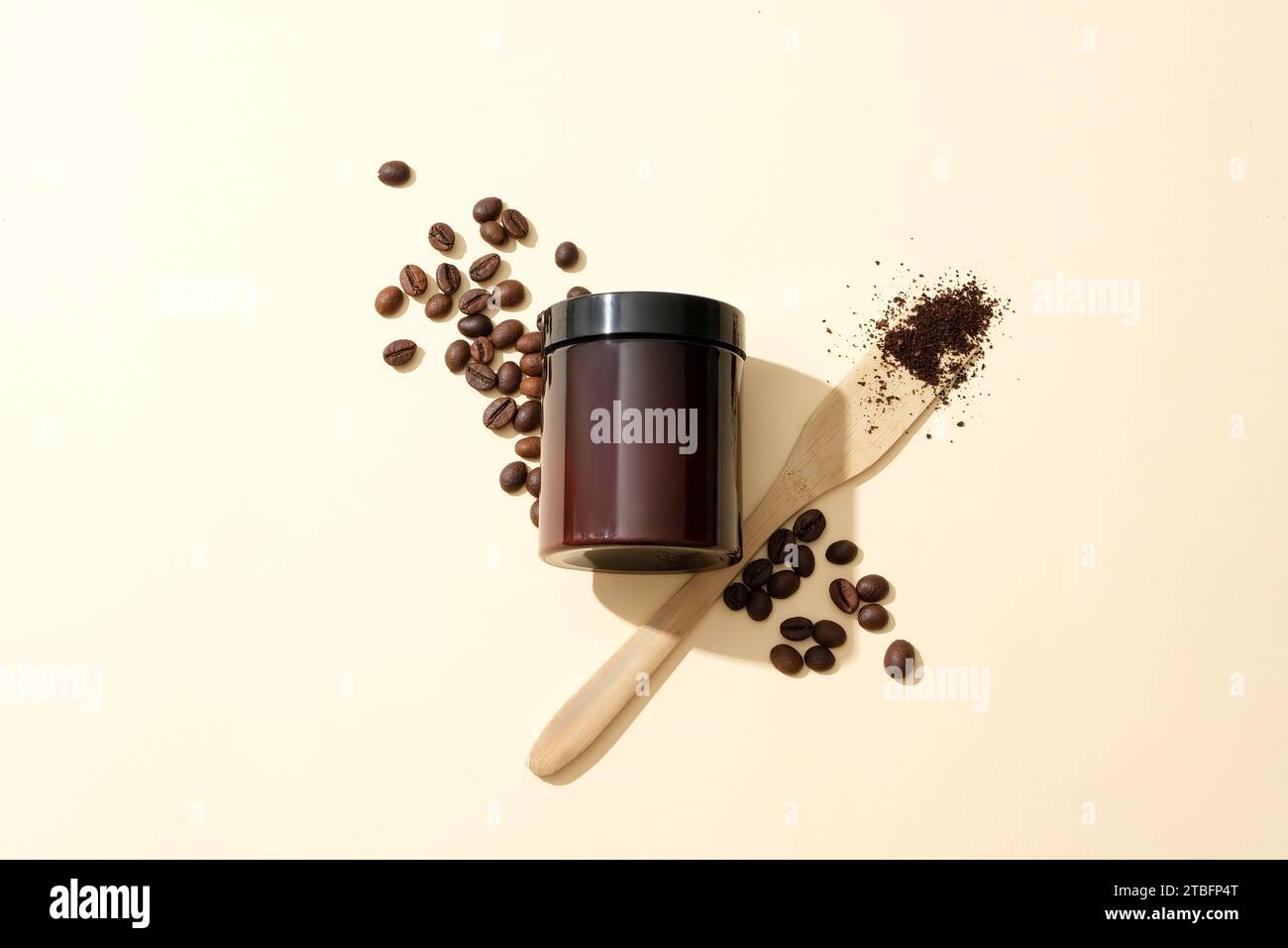 A brown scrub jar stands out against a pastel pink background with ...