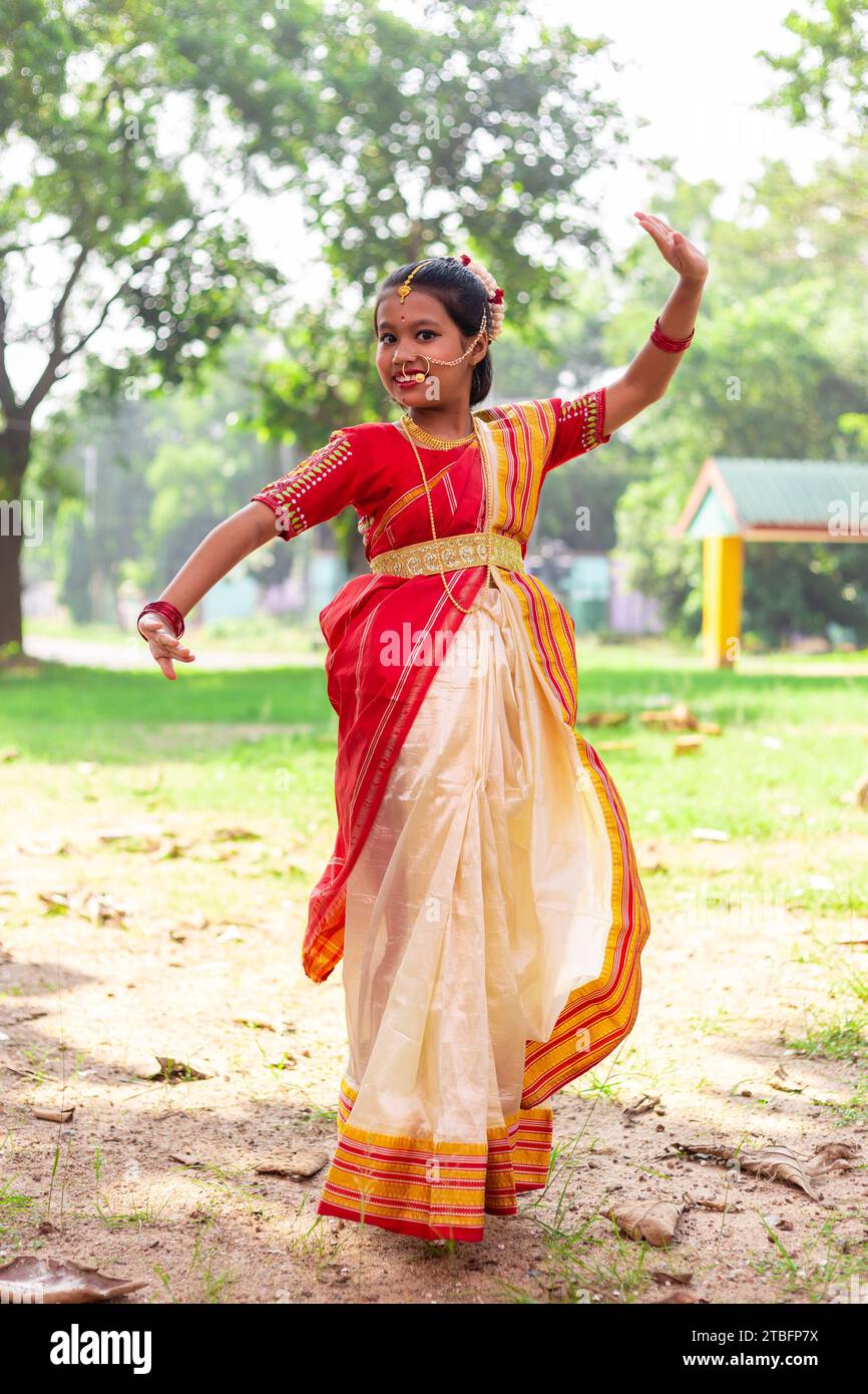 A pretty beautiful Indian girl child in traditional dancing dress, red ...