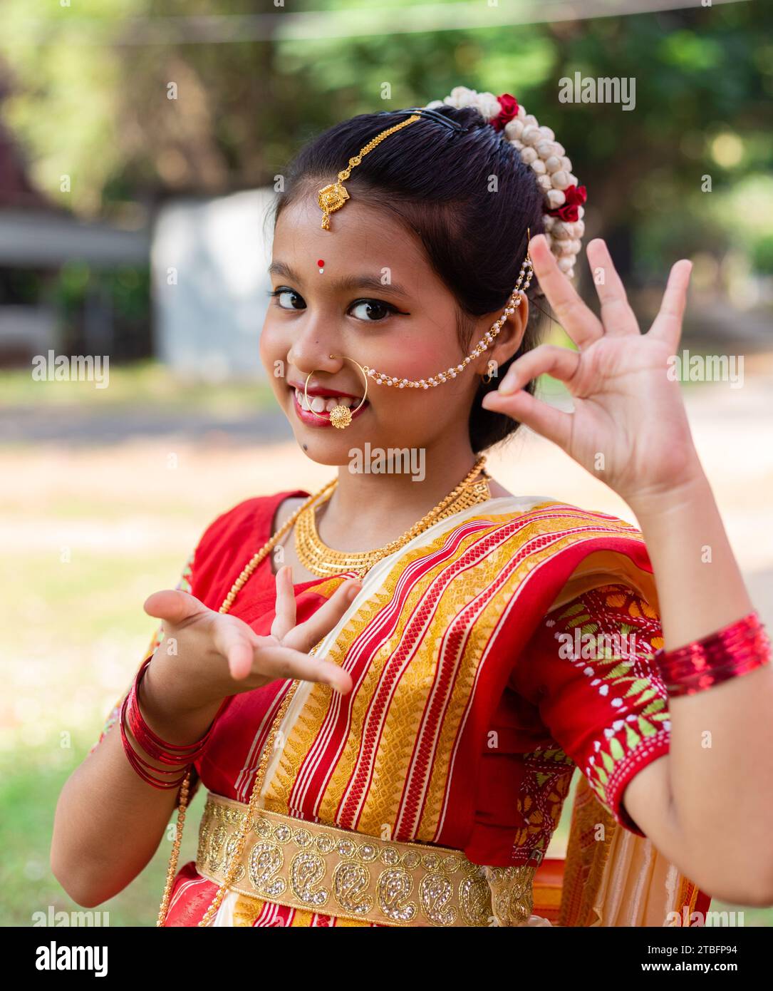 A pretty beautiful Indian girl child in traditional dancing dress, red ...