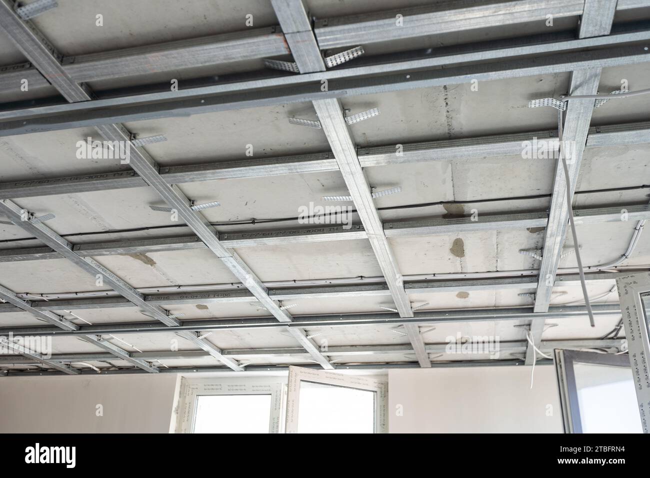 Construction worker installation ceiling work Stock Photo - Alamy