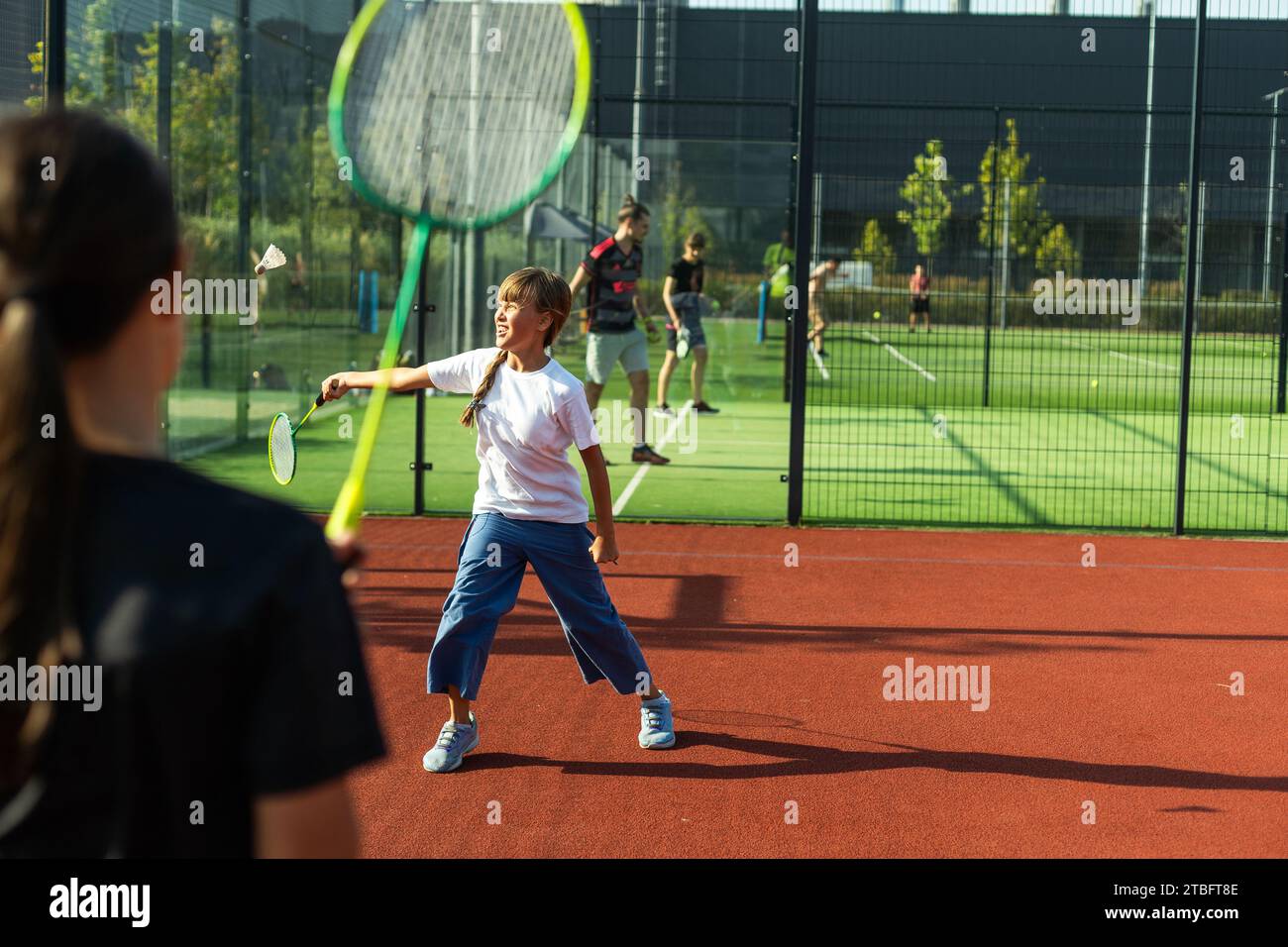 Two girls with badminton rackets on the football field Stock Photo - Alamy