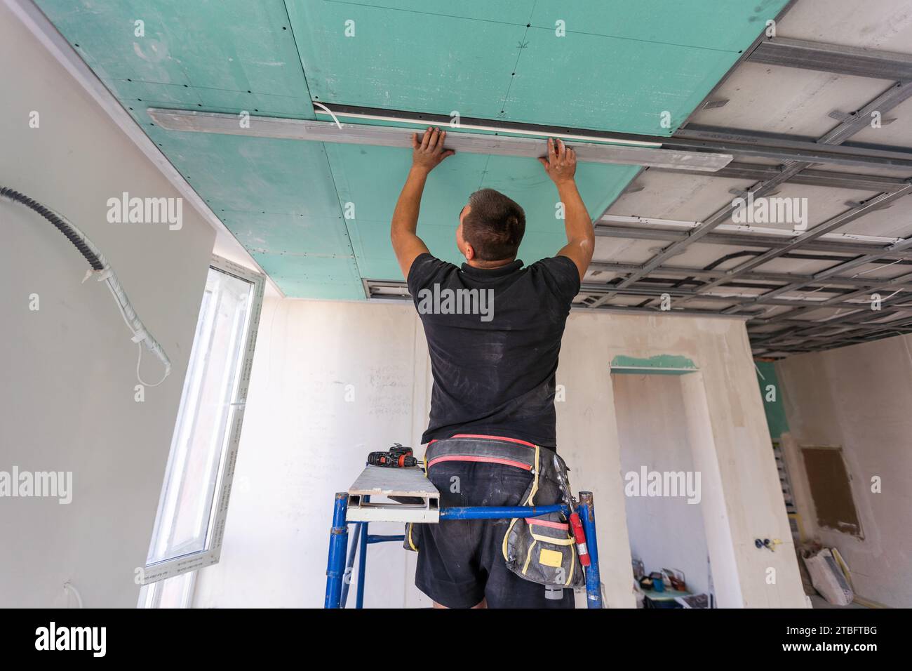 Drywall Installers. Men holding a gypsum board figured cut Stock Photo ...