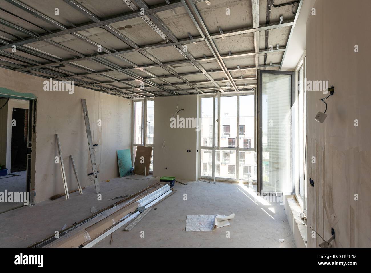 Drywall installation work in progress by construction workers at ...