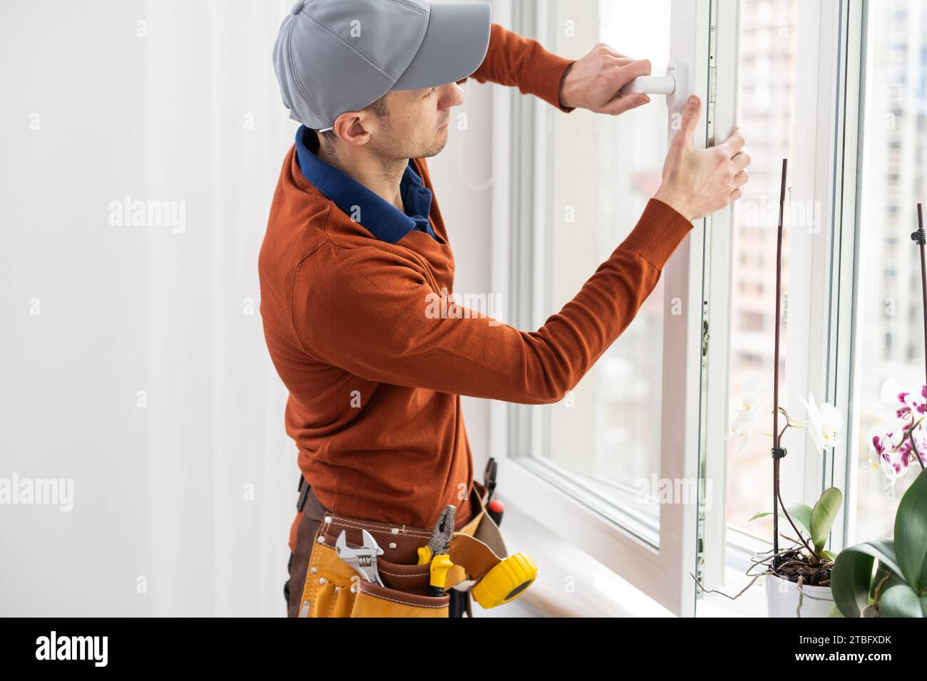 Construction worker installing window in house Stock Photo - Alamy