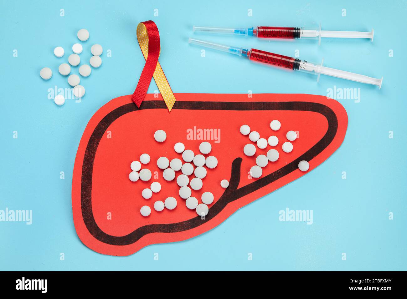 A stethoscope and liver shape made of paper on a white background. Top ...