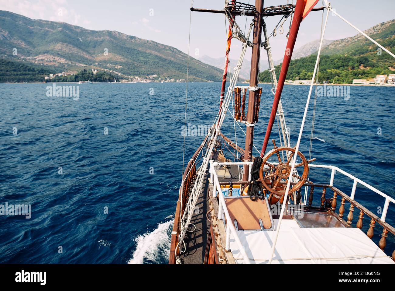 Deck of a wooden ship with a steering wheel sailing on the sea Stock ...