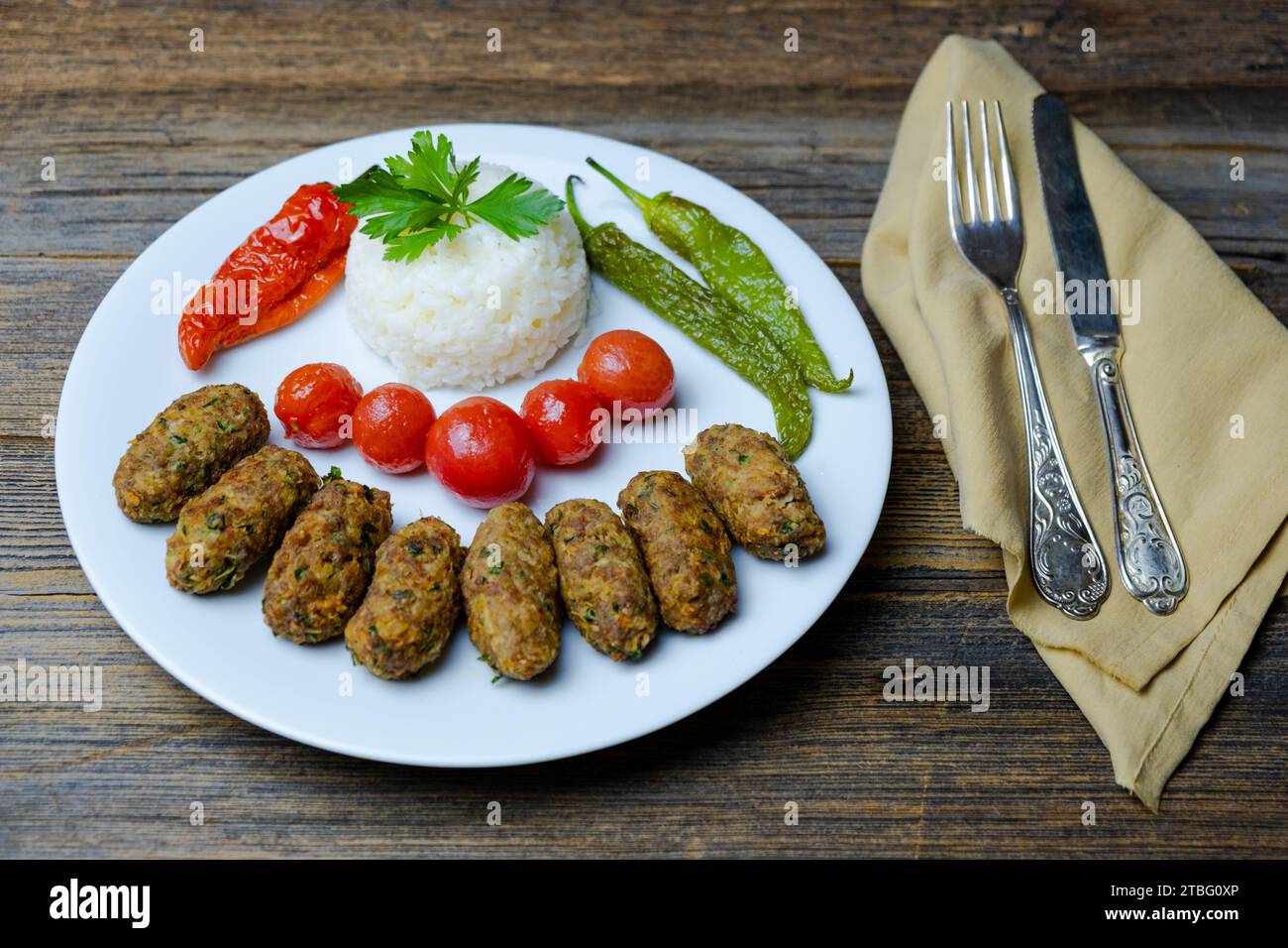 Cyprus meatballs, served with fried peppers, rice pilaf, and tomatoes ...