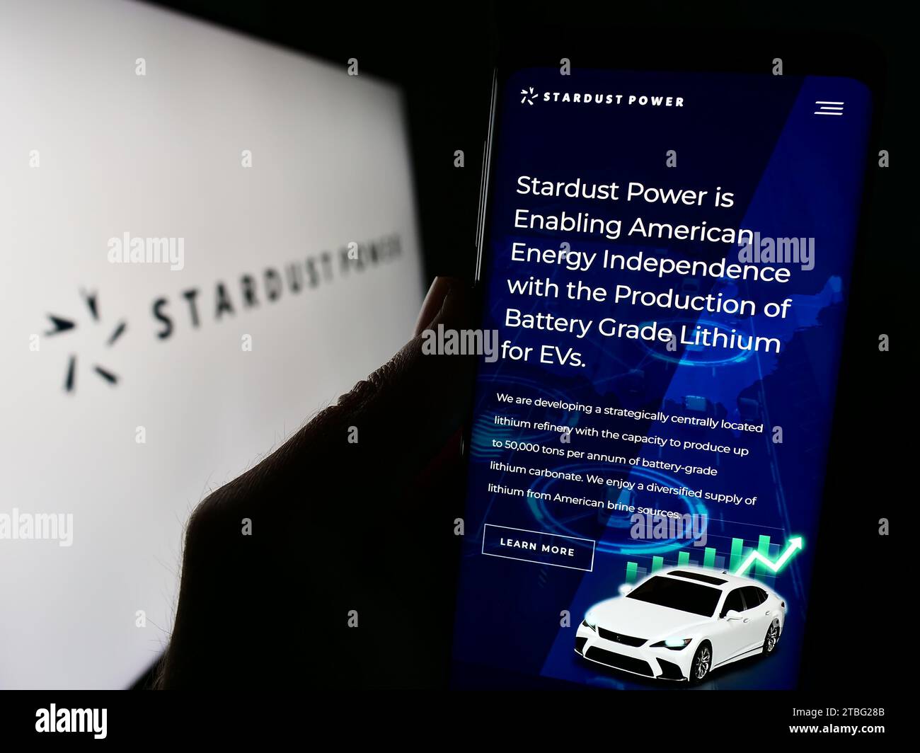 Person holding smartphone with website of US lithium refining company Stardust Power Inc. in ...