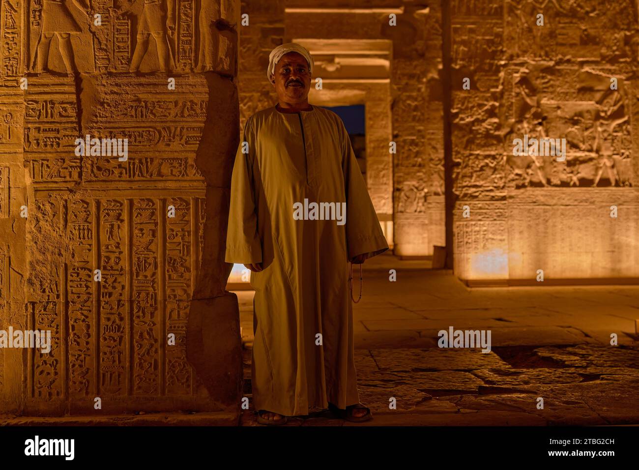 A man wearing a traditional robe stands in a pyramid with ancient ...