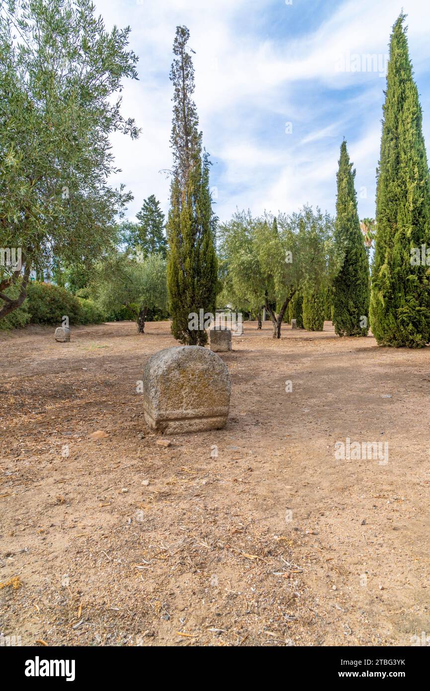 Dirt path in a garden between tombstones and Roman stone mausoleums and ...