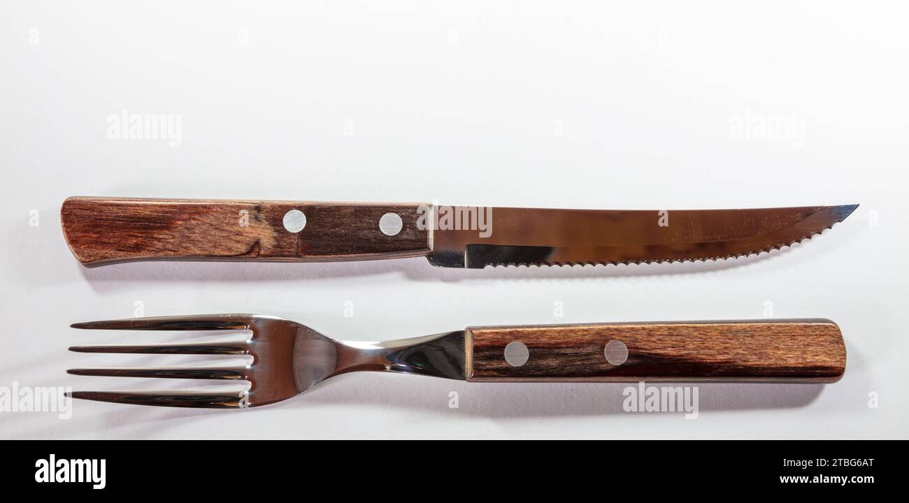 A close-up shot of a fork and knife with wooden handles Stock Photo - Alamy