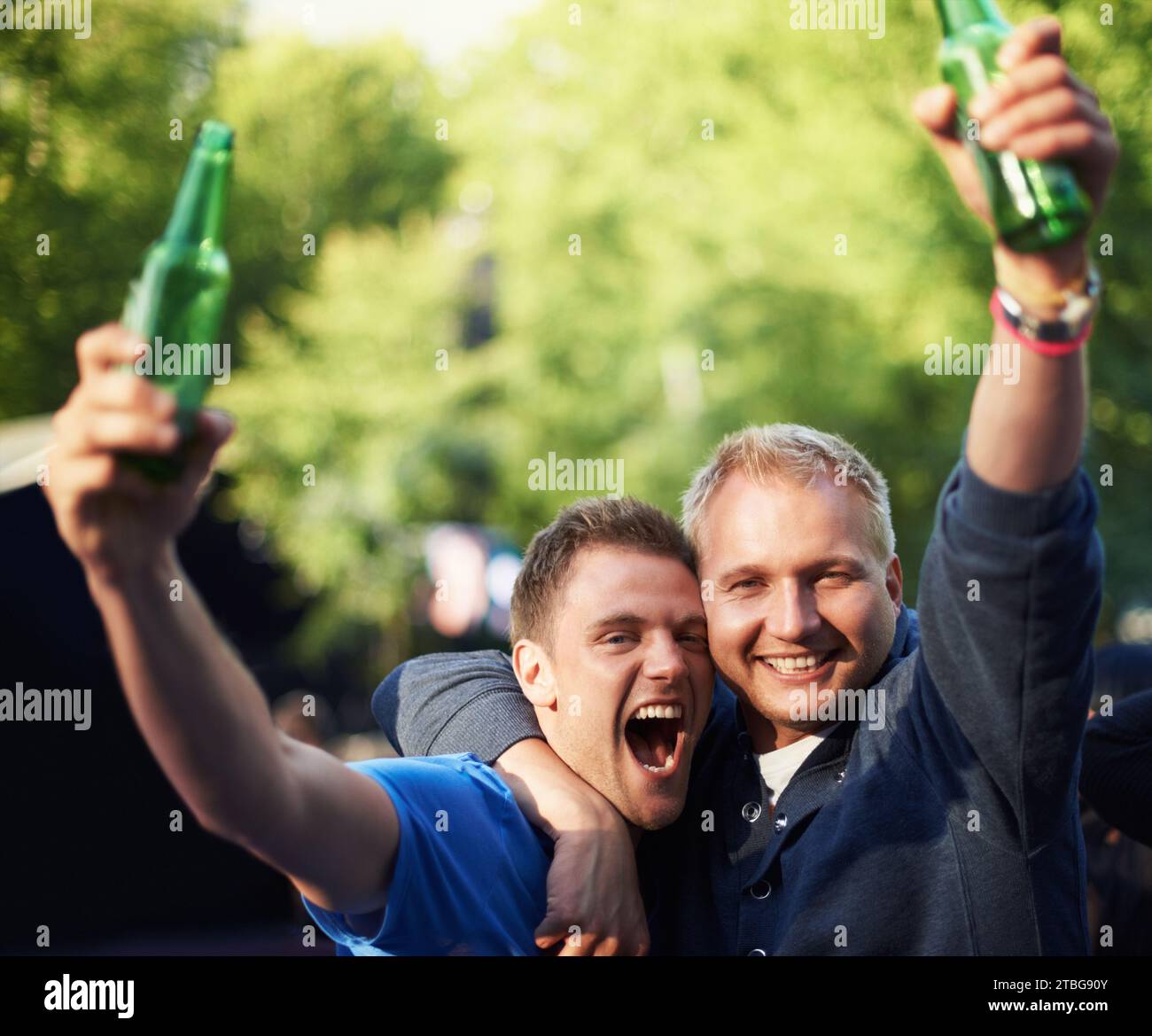 Portrait of men at music festival with cheers, beer and excited hug in ...