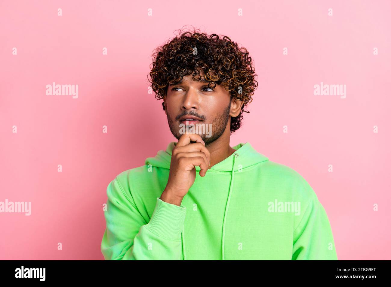 Portrait of indian young serious guy brainstorming touching chin ...