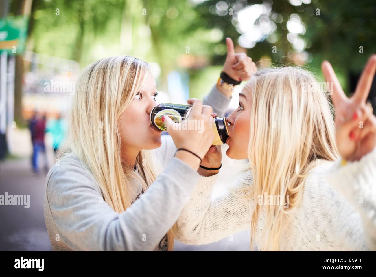 Beer can, festival friends and women drinking for fun together, soda ...