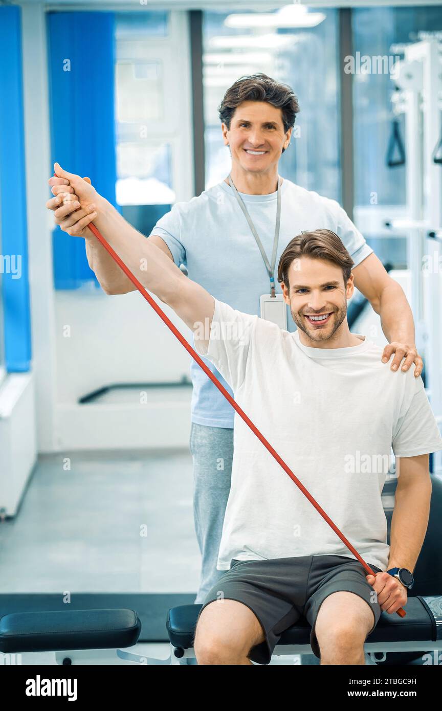 Physical therapy. Young man having a physical therapy session with a ...