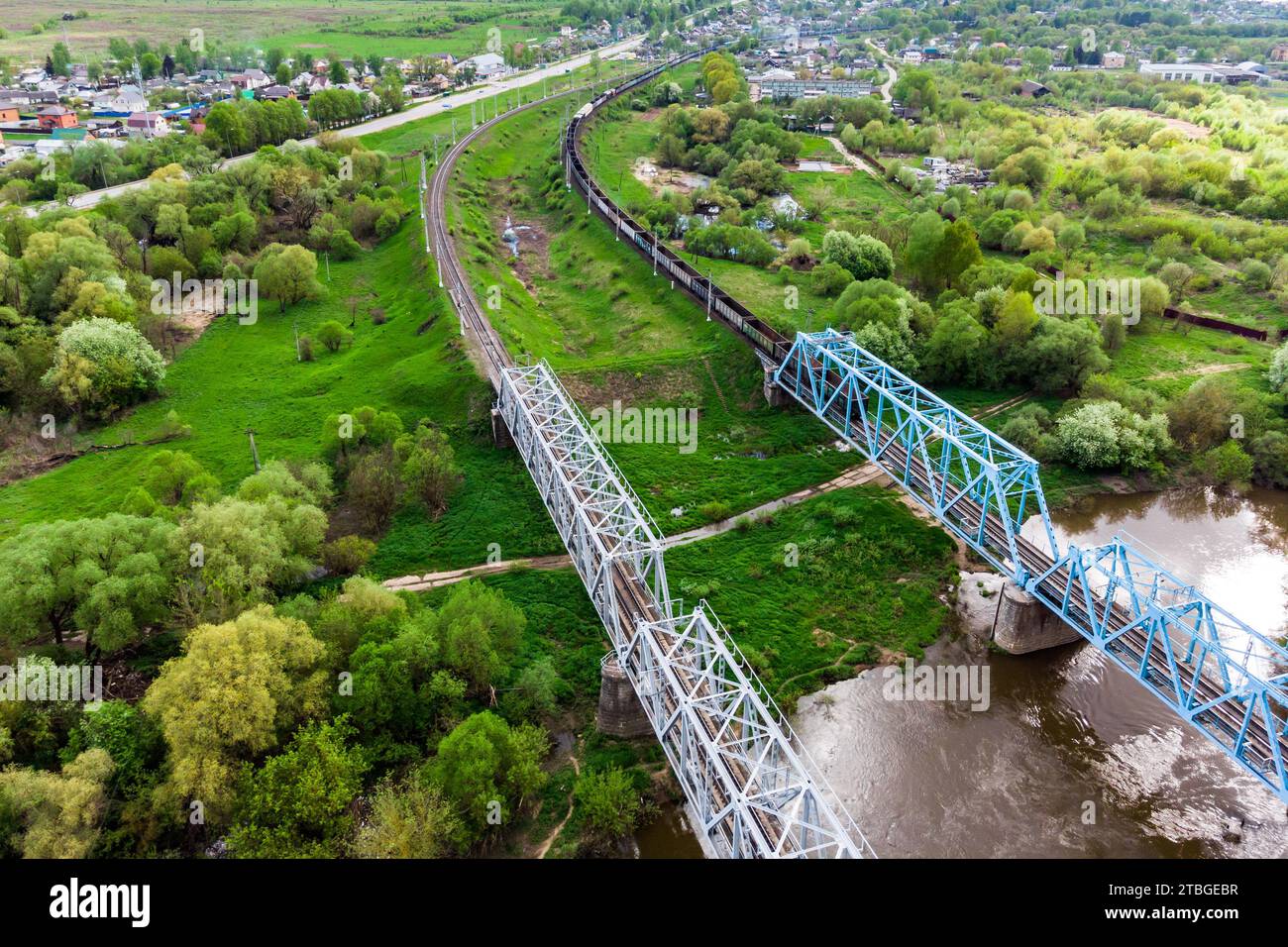Aerial view of metal railway bridges and the tail of a railway freight ...