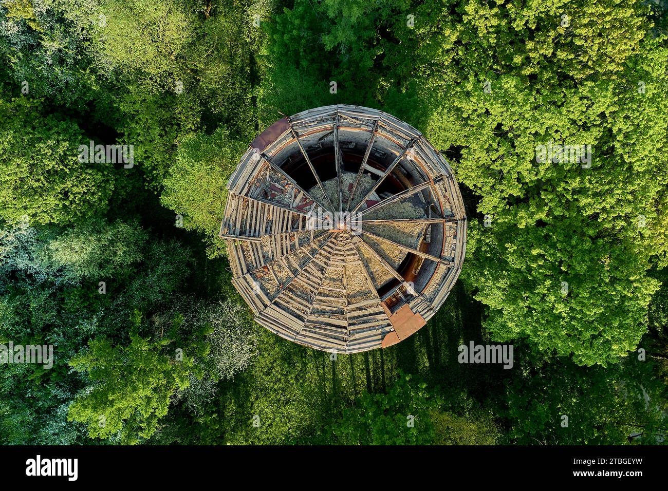Aerial view of the leaky round shaped roof of an old water tower among ...