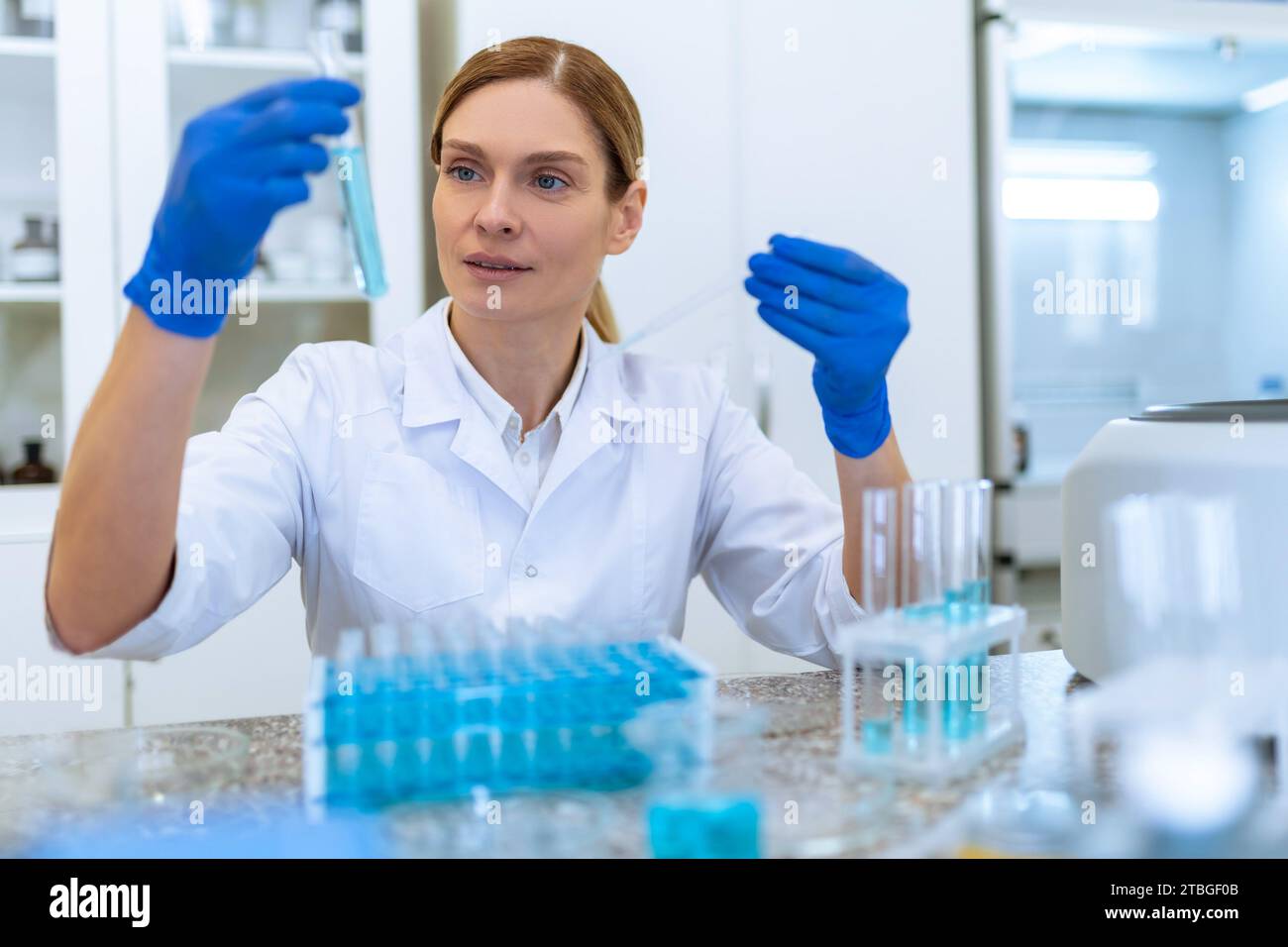 Blonde successful woman researcher working with medical samples ...