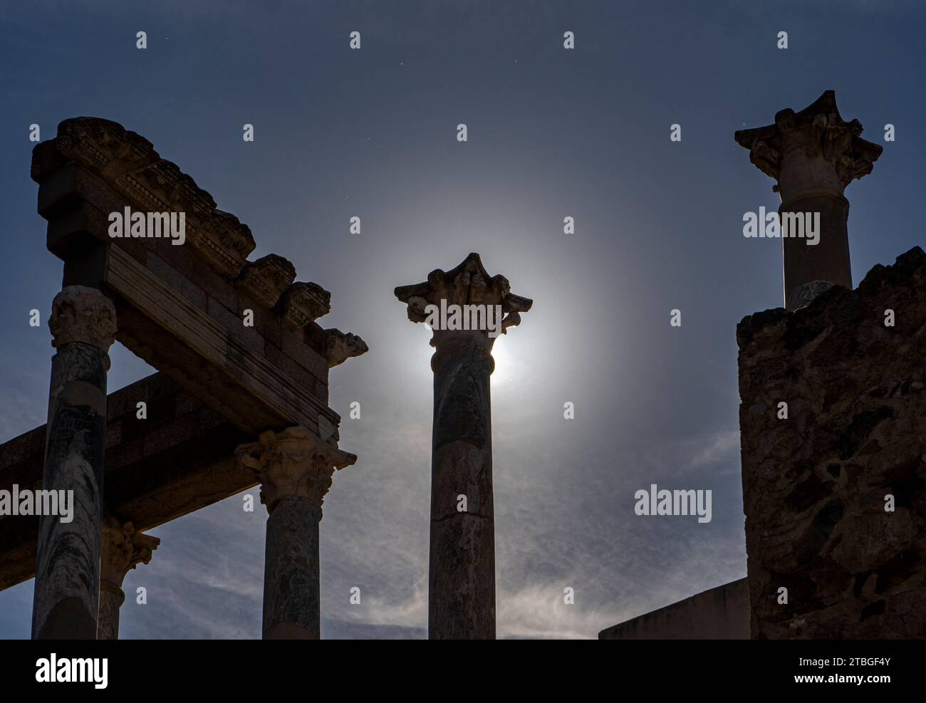 Backlit silhouette with the capital of a column blocking the light of ...