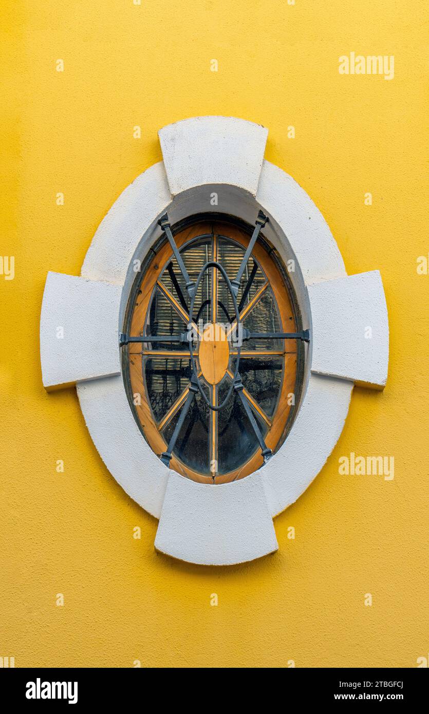 Old and handcrafted classic oval window with wrought iron grille and ...