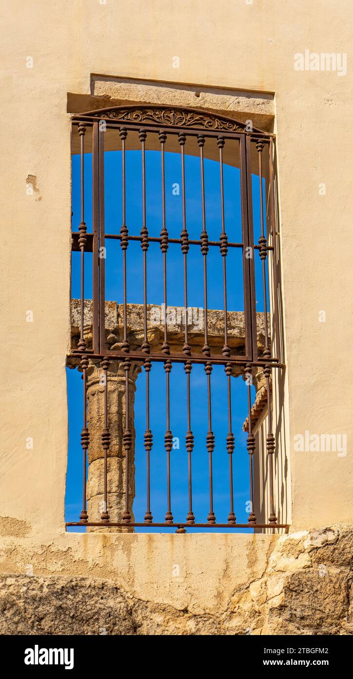 Old renovated wrought iron grille of the window of the facade of the ...