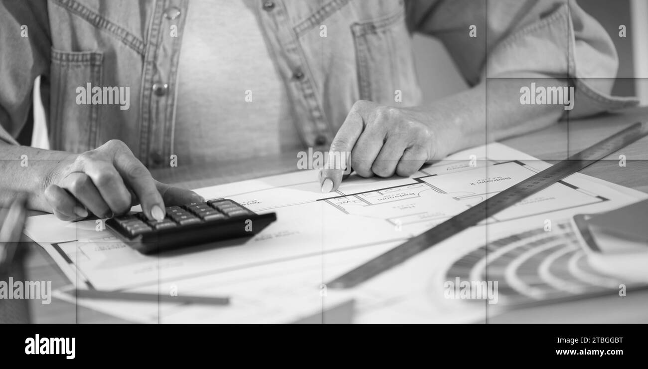 Woman architect engineer blueprint calculator Black and White Stock ...