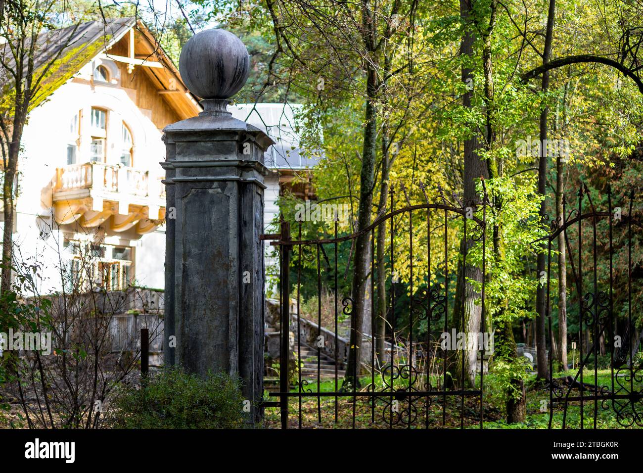 Decorative gate with an antique column standing in front of an old ...