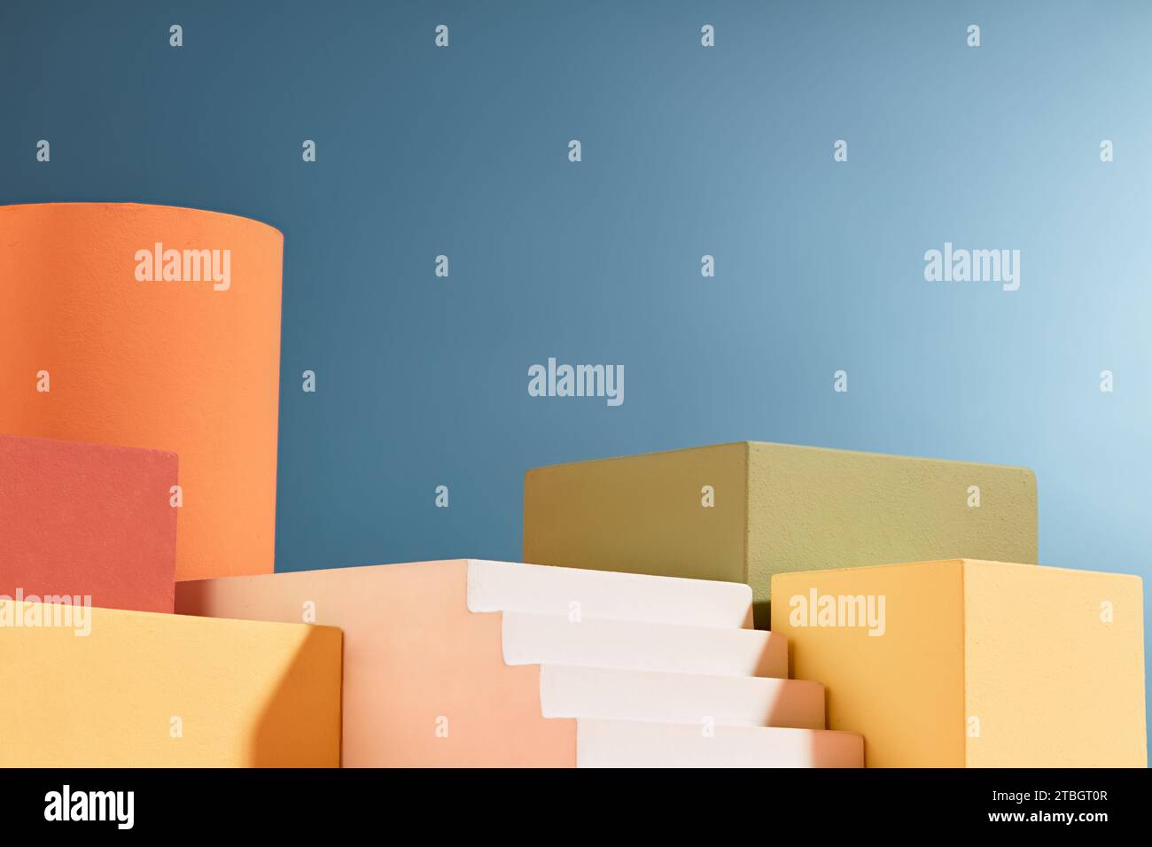 Geometric shape podiums decorated against blue background with vacant ...