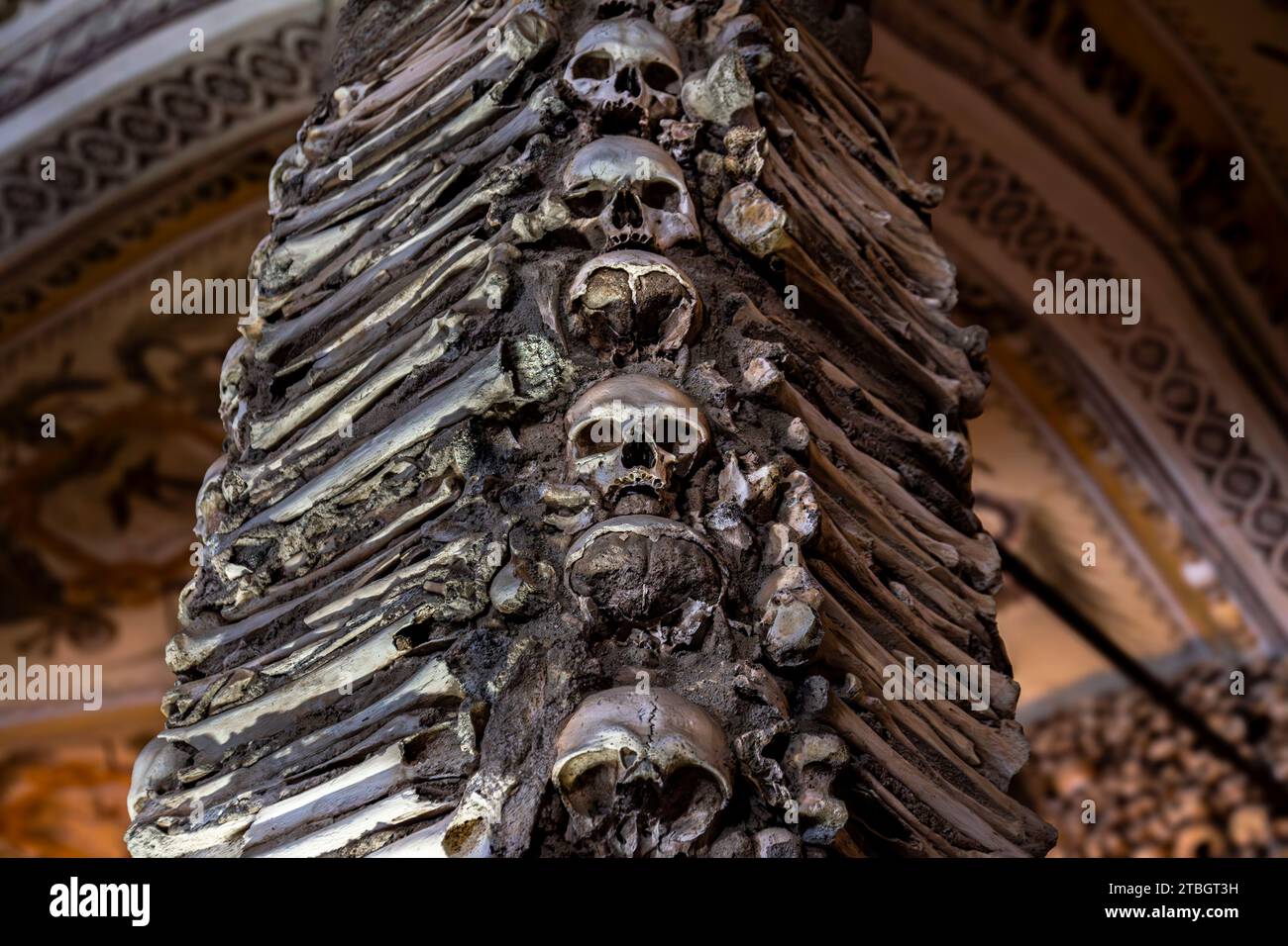 Column of human skulls with bones on the sides creating a macabre ...