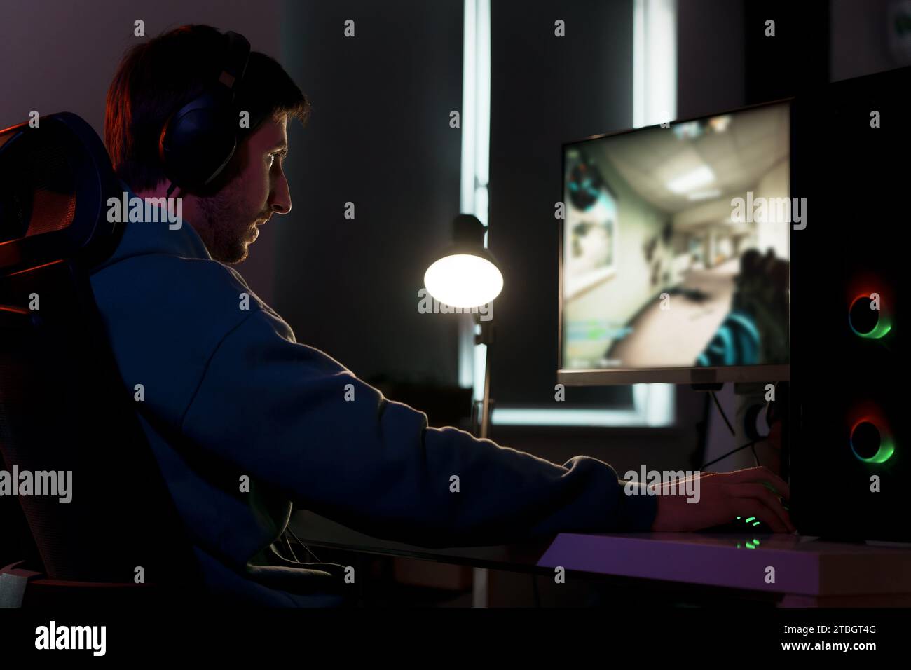 Focused cybersport gamer playing video game on computer Stock Photo - Alamy