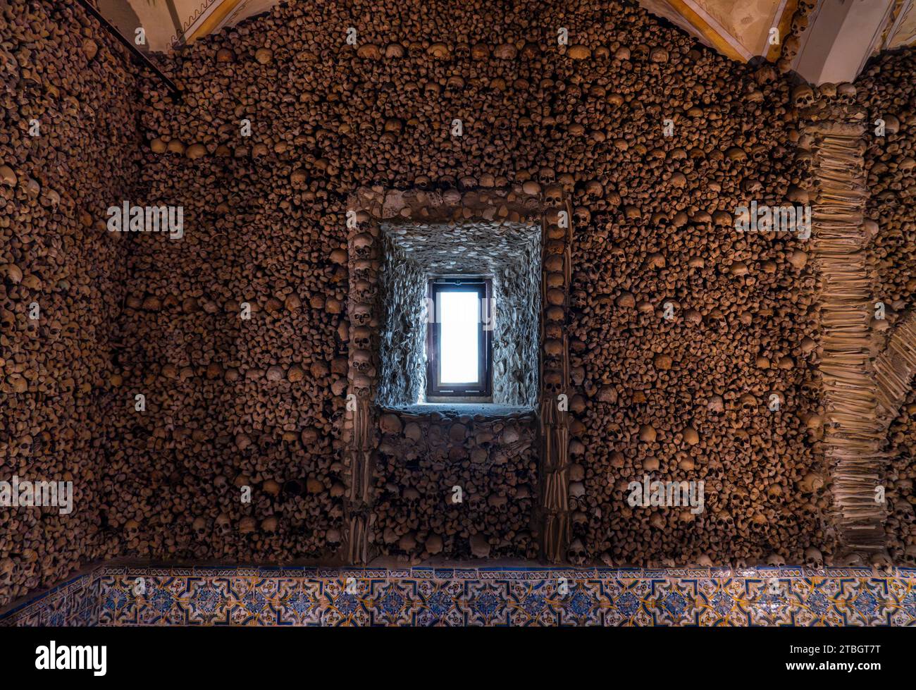 Frame, window and church wall decorated with human bones and skulls ...