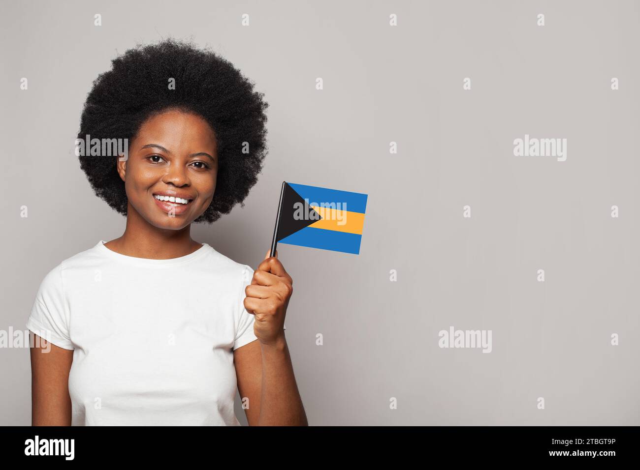 Bahamian woman holding flag of Bahamas Education, business, citizenship ...