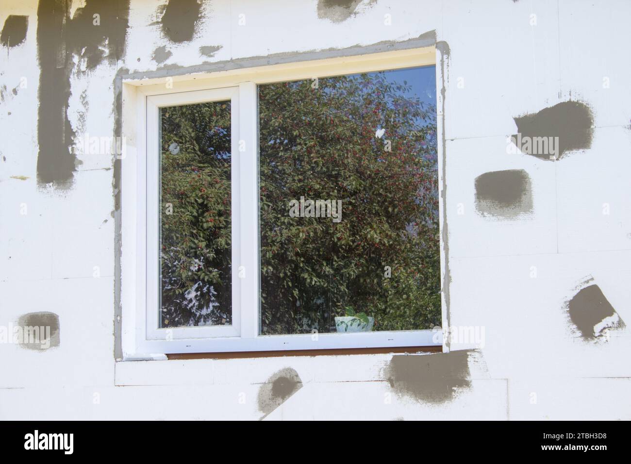 insulation of the facade of the building, the window is white with ...