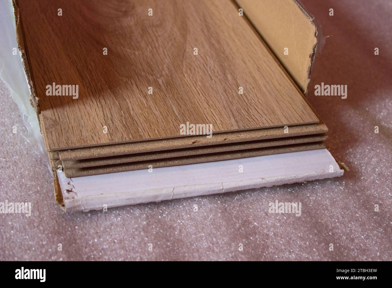 Packing with a wooden laminate for floor installation Stock Photo - Alamy