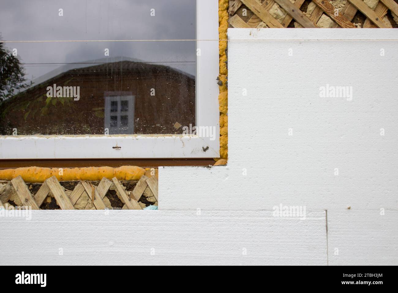 Builder installing rigid styrofoam insulation board for energy saving ...