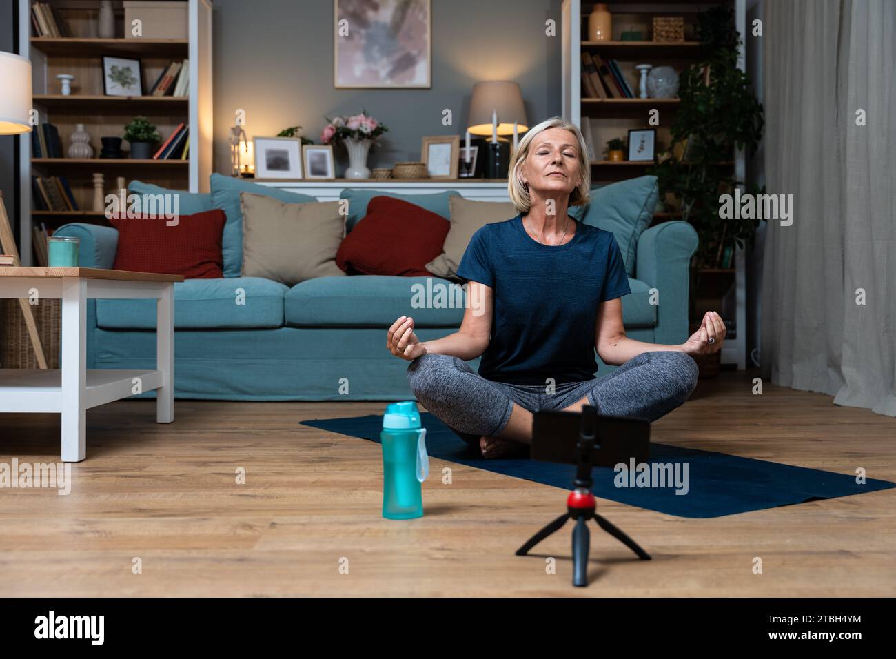 Attractive senior woman learning new exercises watching online workout ...